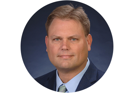 Carl G. Simon, circular headshot